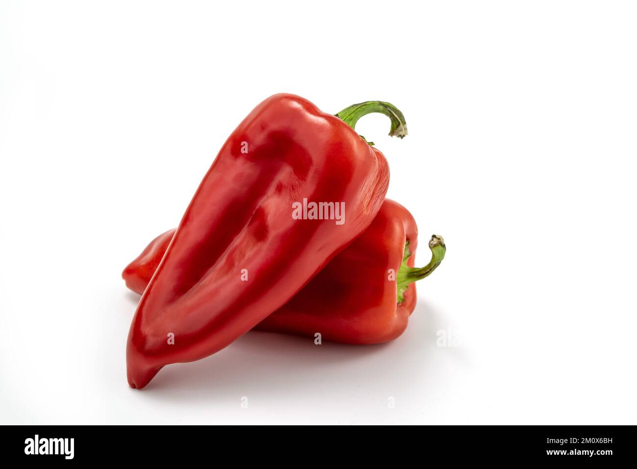 Two fresh sweet red peppers paprika isolated on white background ...