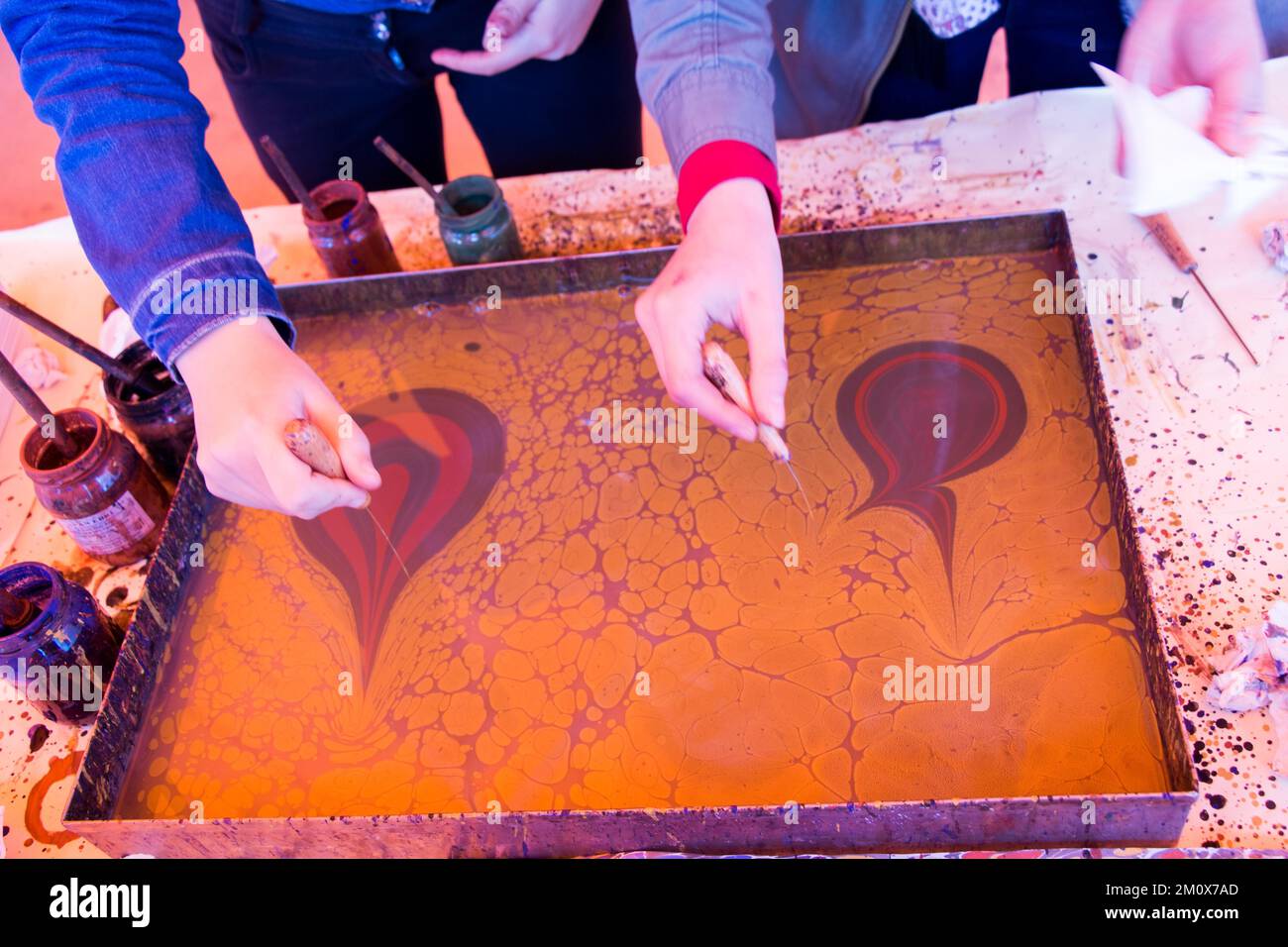 Hand drawing with stick stained inks on water surface Stock Photo - Alamy