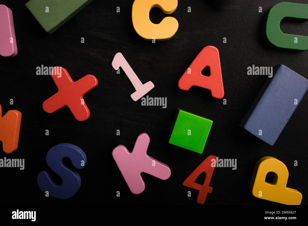 Wooden numbers, letters and blocks on a black background Stock Photo ...