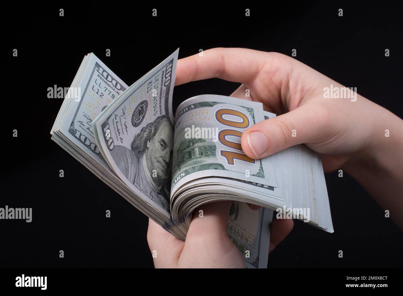 Hand holding American dollar banknotes isolated on white background ...