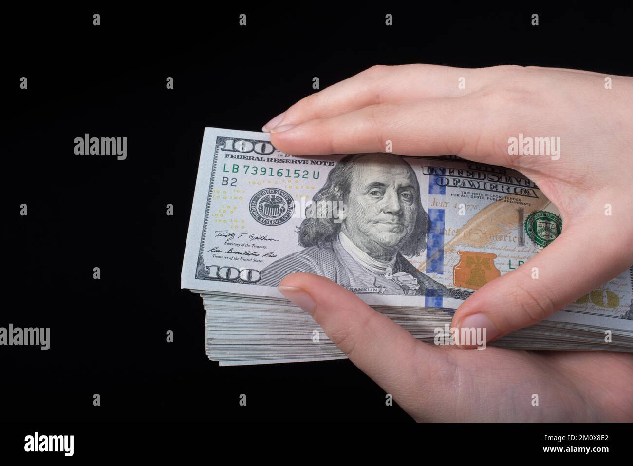 Hand holding American dollar banknotes isolated on white background ...