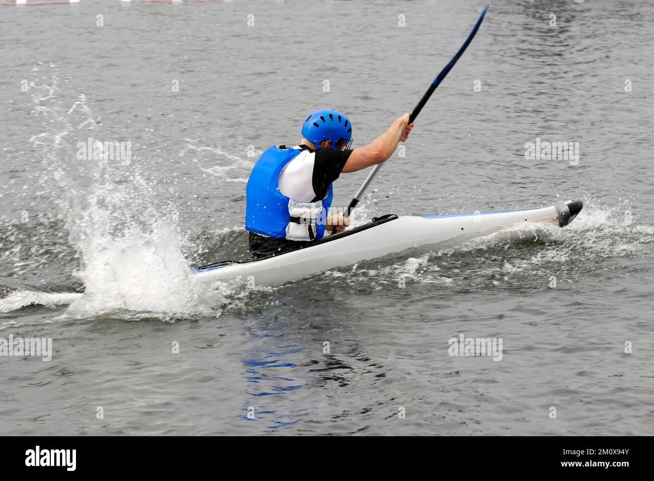 Man in kayak making water splash Stock Photo - Alamy