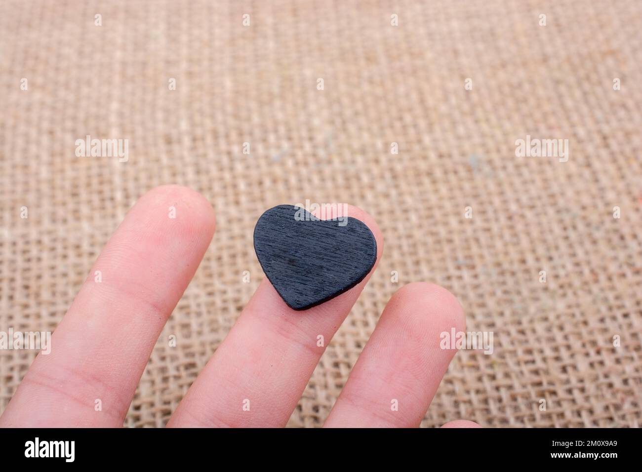 Heart shaped object in hand on canvas Stock Photo - Alamy