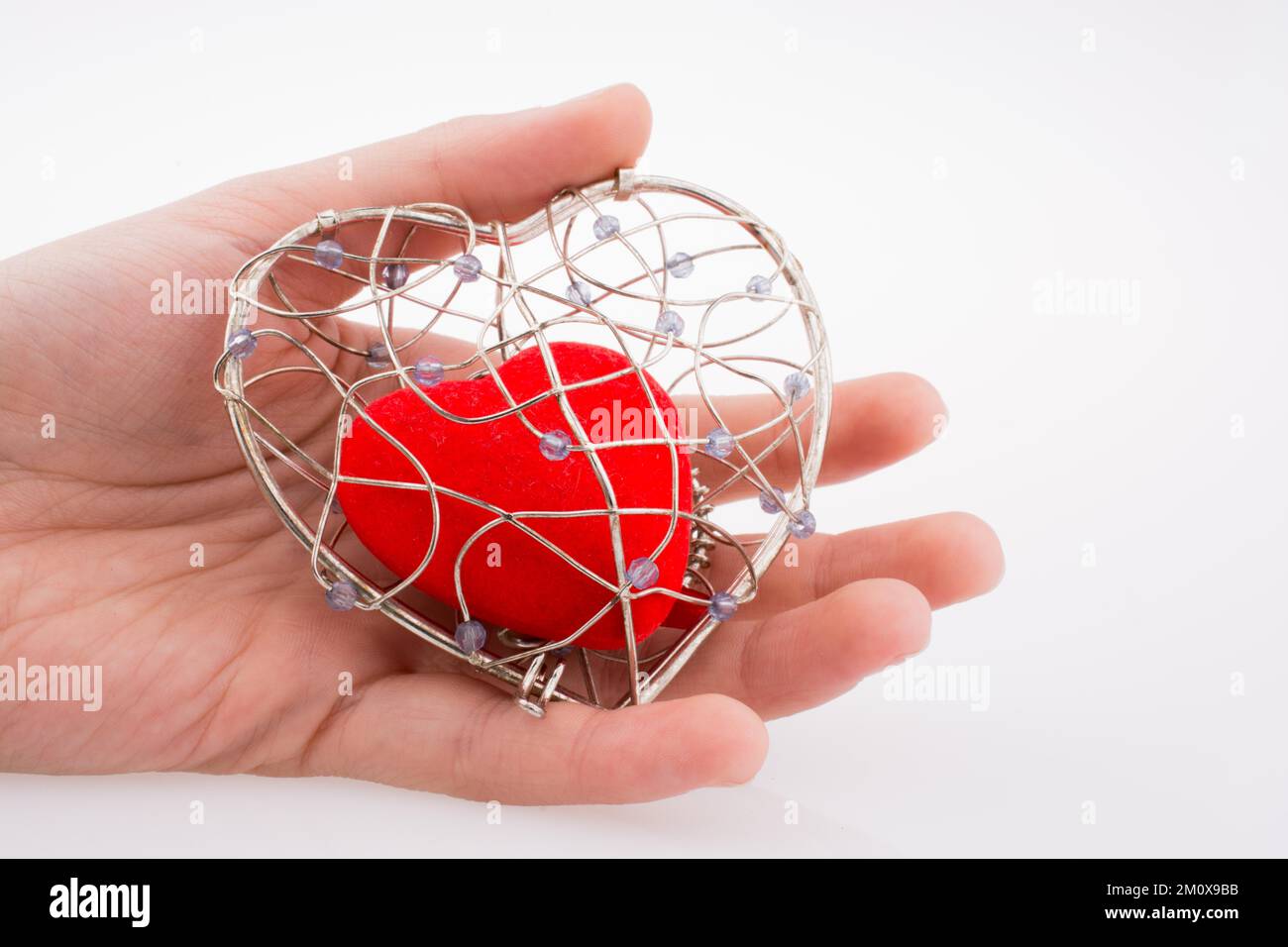 Red heart in a heart shaped cage Stock Photo - Alamy