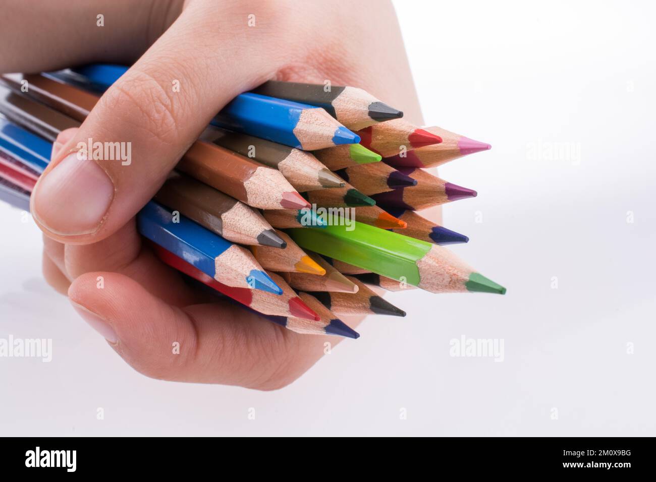 Hand holding color pencils on a white background Stock Photo - Alamy