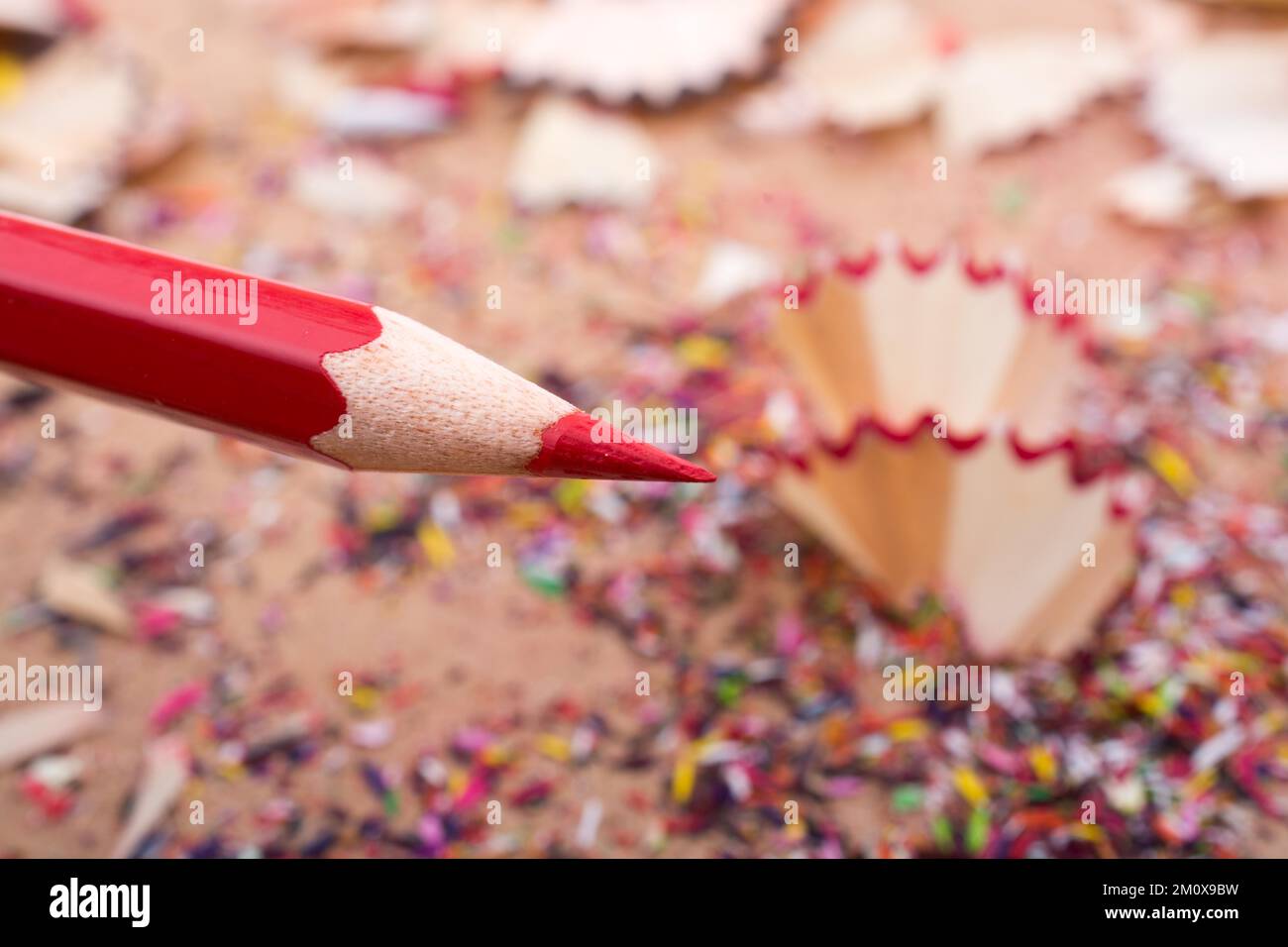 Red Color Pencil over some pencil shavings Stock Photo - Alamy