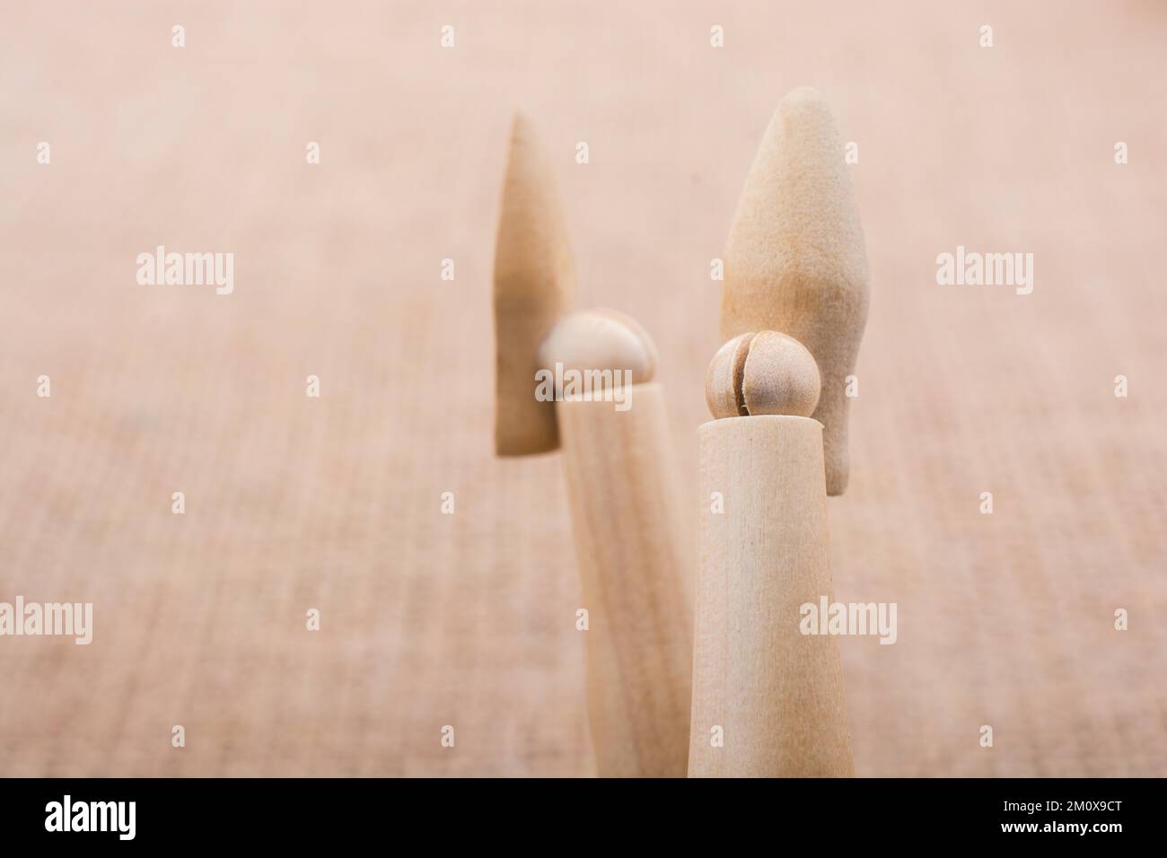 Wooden dolls posing with his legs on canvas Stock Photo - Alamy