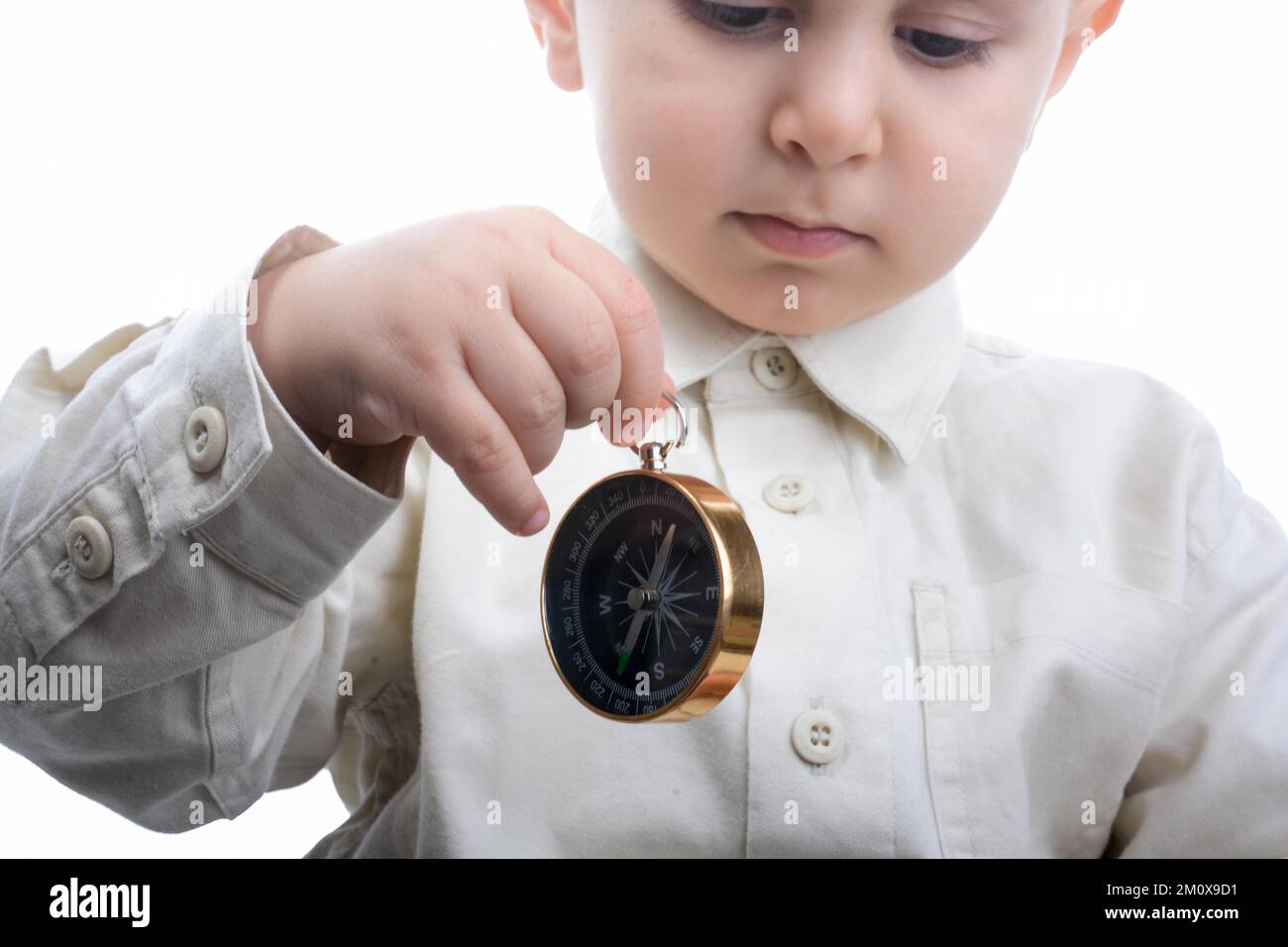 Isolated compass in baby's hand on a white background Stock Photo - Alamy