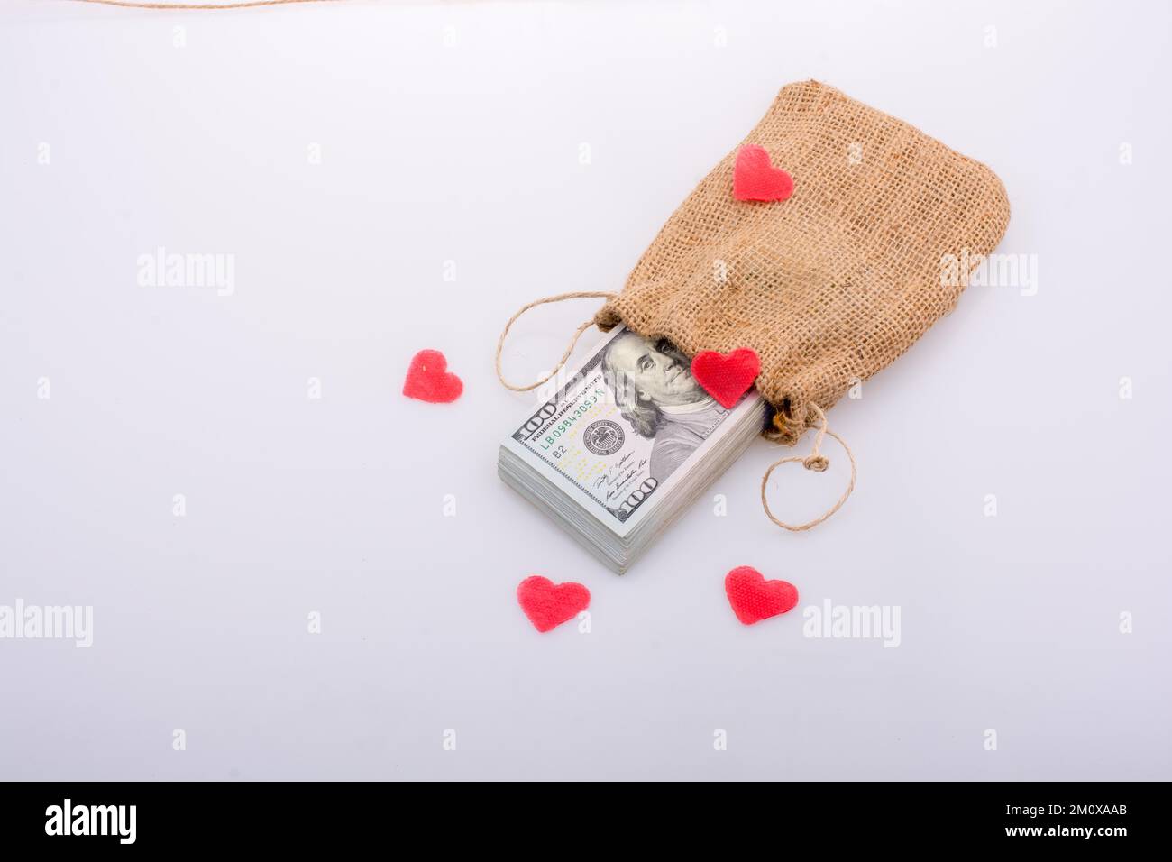 Red hearts and banknote bundle of US dollarin a sack Stock Photo - Alamy