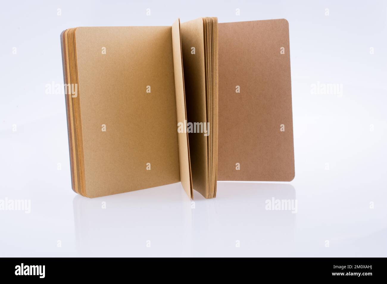 Brown color notebook with open pages on a white background Stock Photo ...