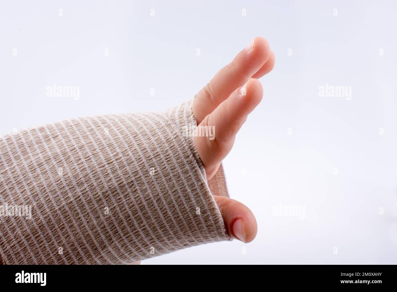 Baby wrist wrapped in bandage on white background Stock Photo - Alamy
