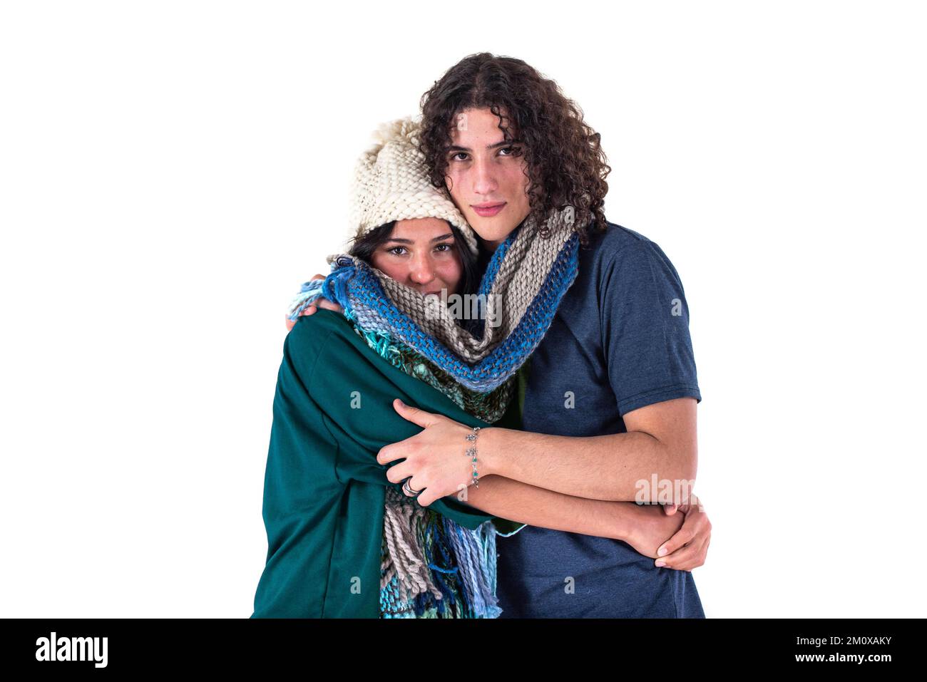 Two friends are hugging each other like they are cold while wearing the ...