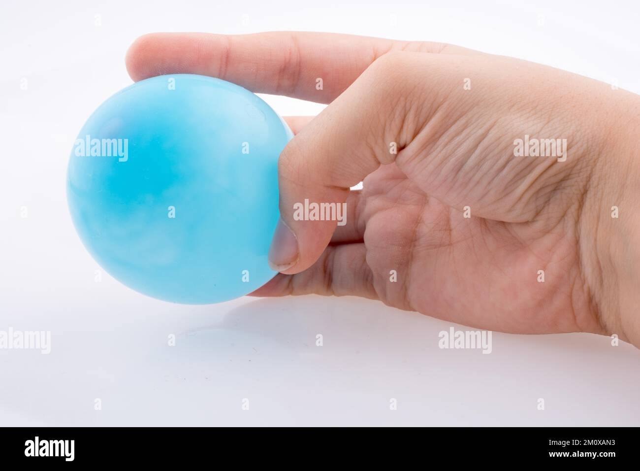 Hand holding a Colorful small balloon on a white background Stock Photo ...