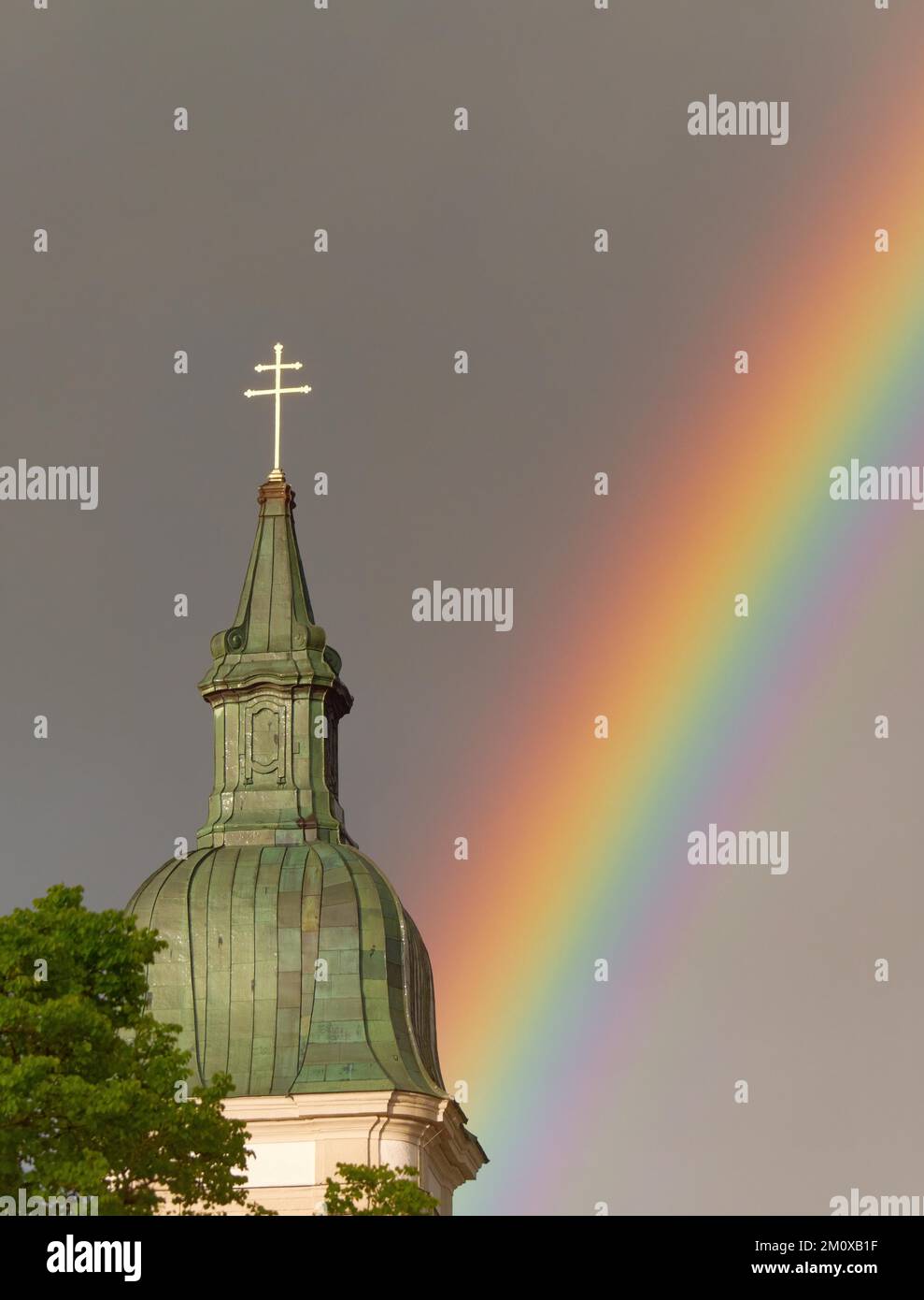 A colorful rainbow behind a german church spire as a positive symbol of ...