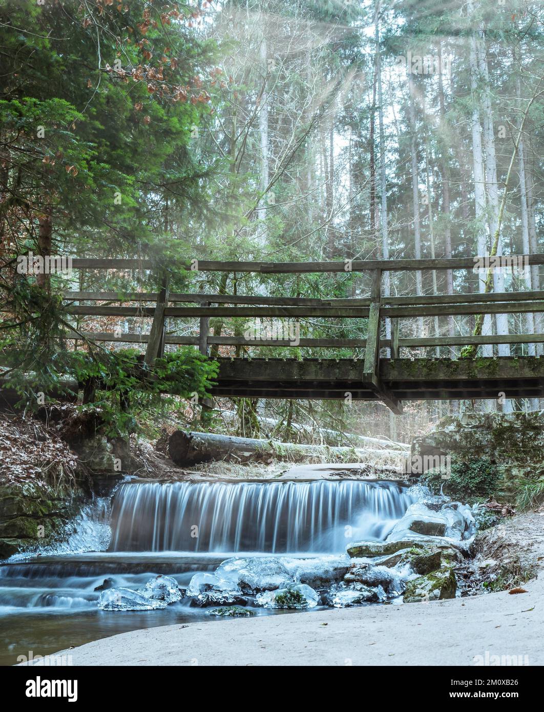 Bridge over a fairy tale waterfall Stock Photo - Alamy