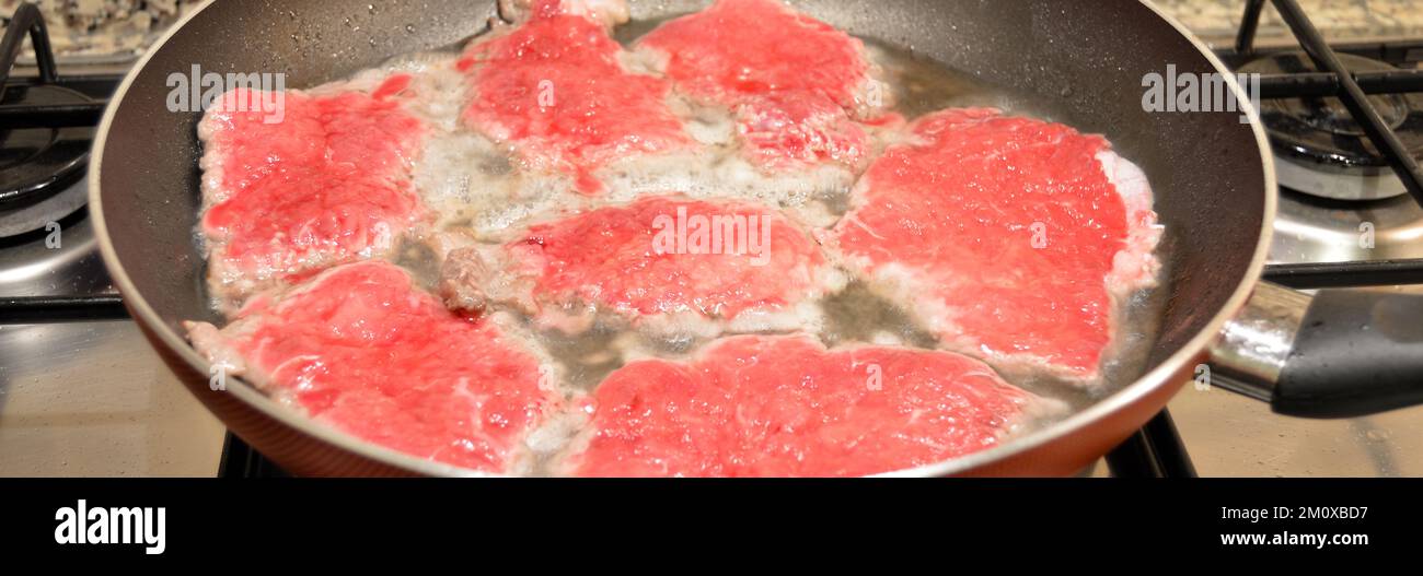 Fresh red cow tenderloin frying in pan on stove, homemade very healthy ...