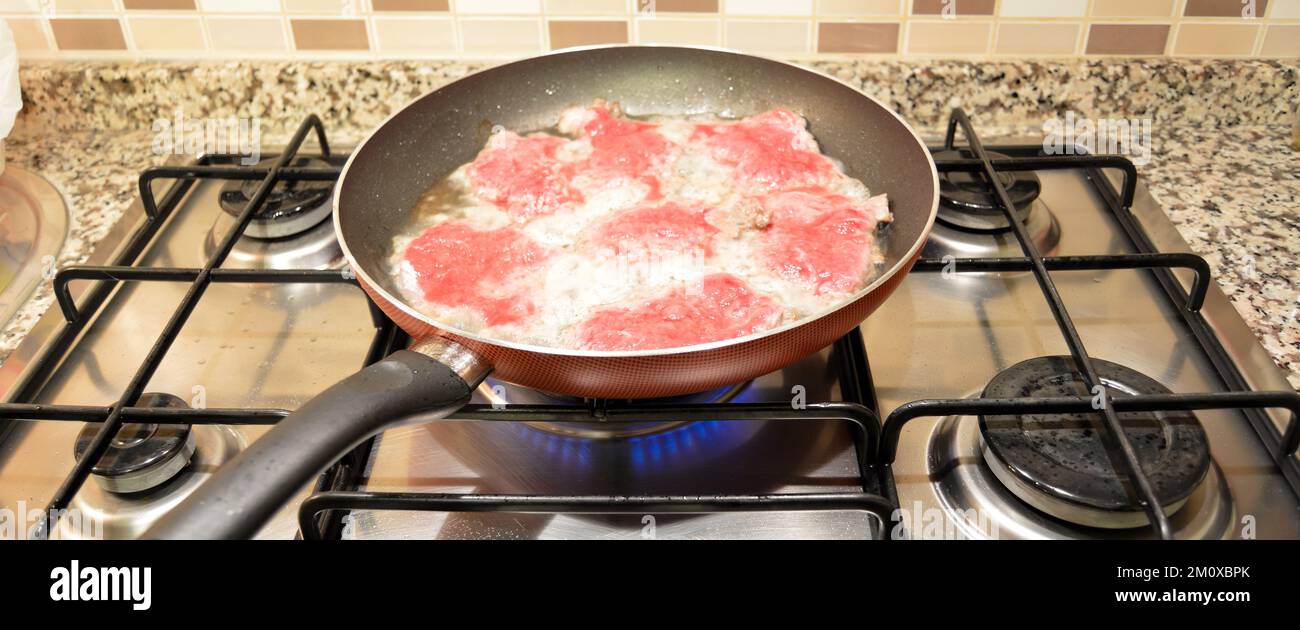 Fresh red cow tenderloin frying in pan on stove, homemade very healthy ...