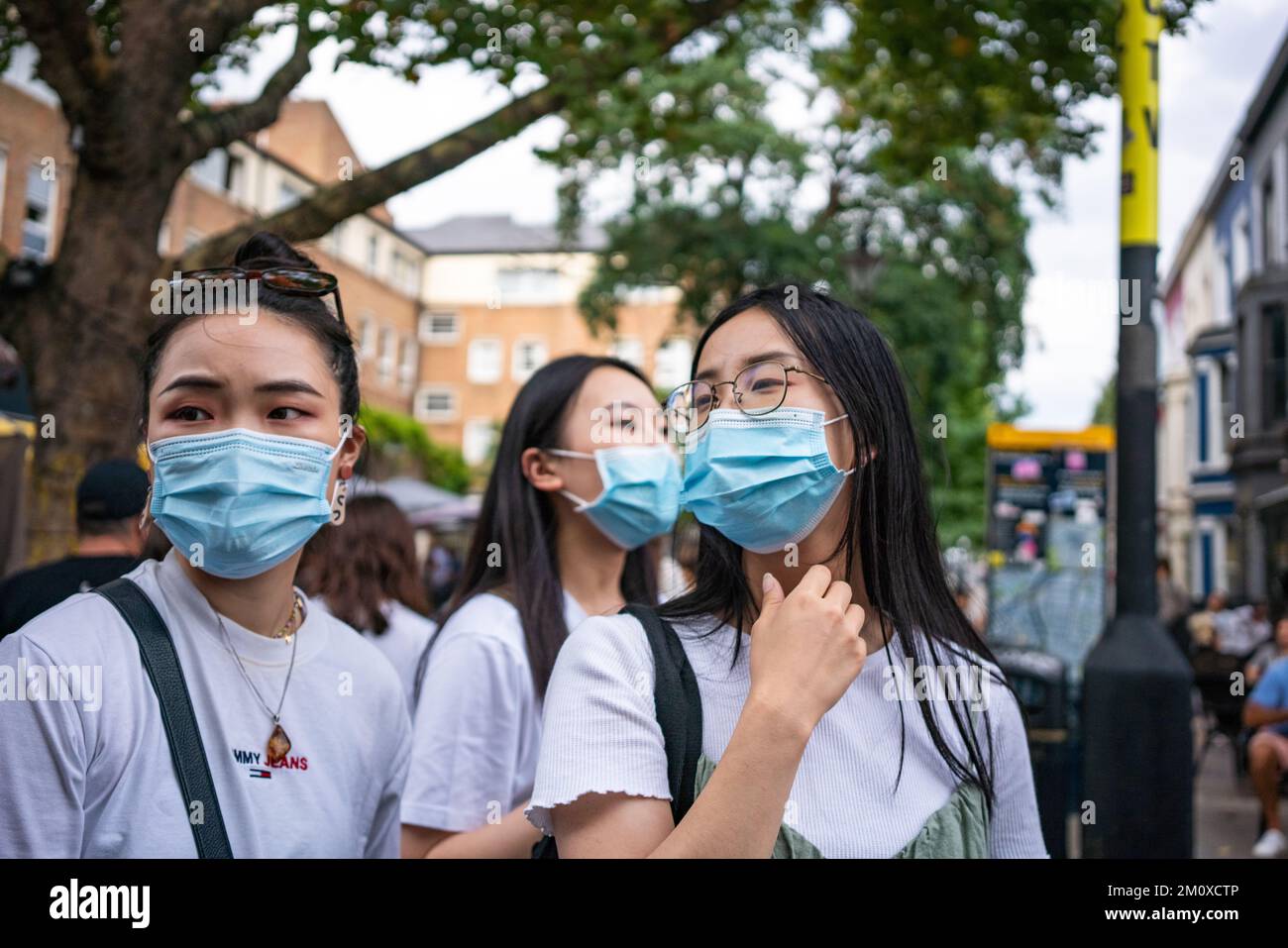 Three asian teenage females wearing covid masks Stock Photo - Alamy