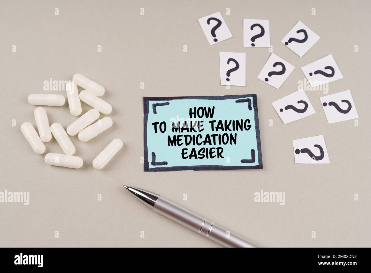 Medical concept. On a gray surface there are question marks and a blue ...