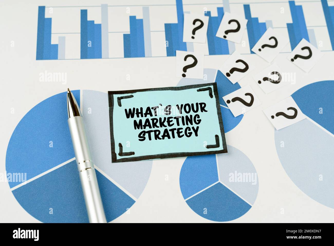 business question concept. On the blue diagrams lies a pen, questions ...