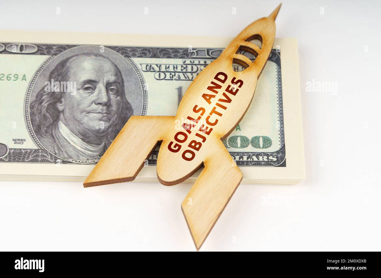 Business concept. On the dollars lies a wooden model of a rocket with ...