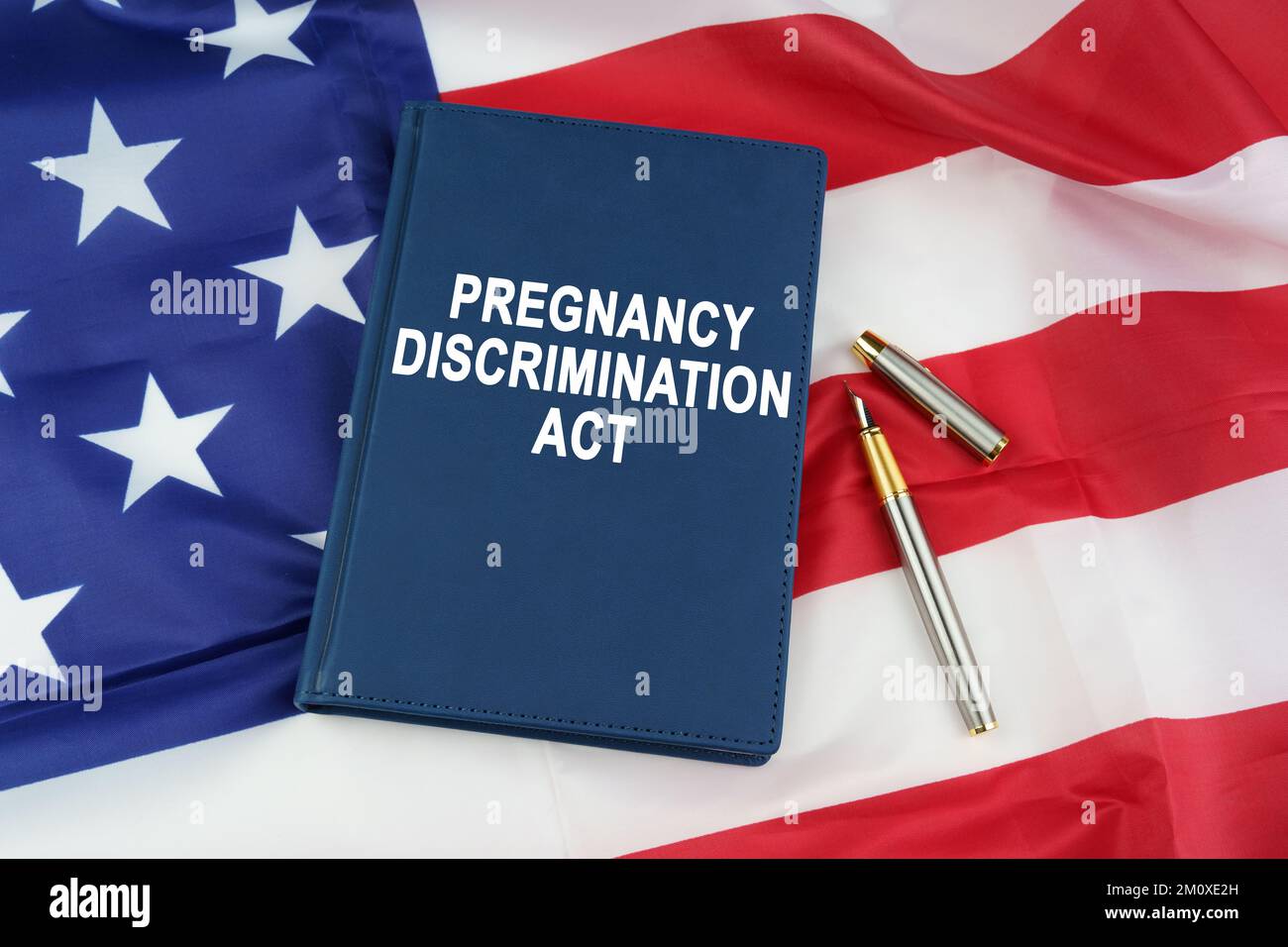 Law concept. On the US flag lies a pen and a book with the inscription ...