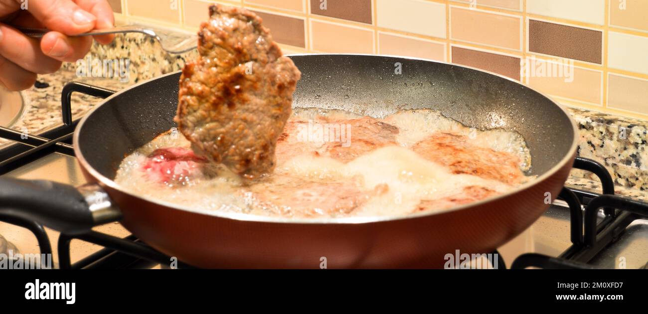 Fresh red cow tenderloin frying in pan on stove, homemade very healthy ...