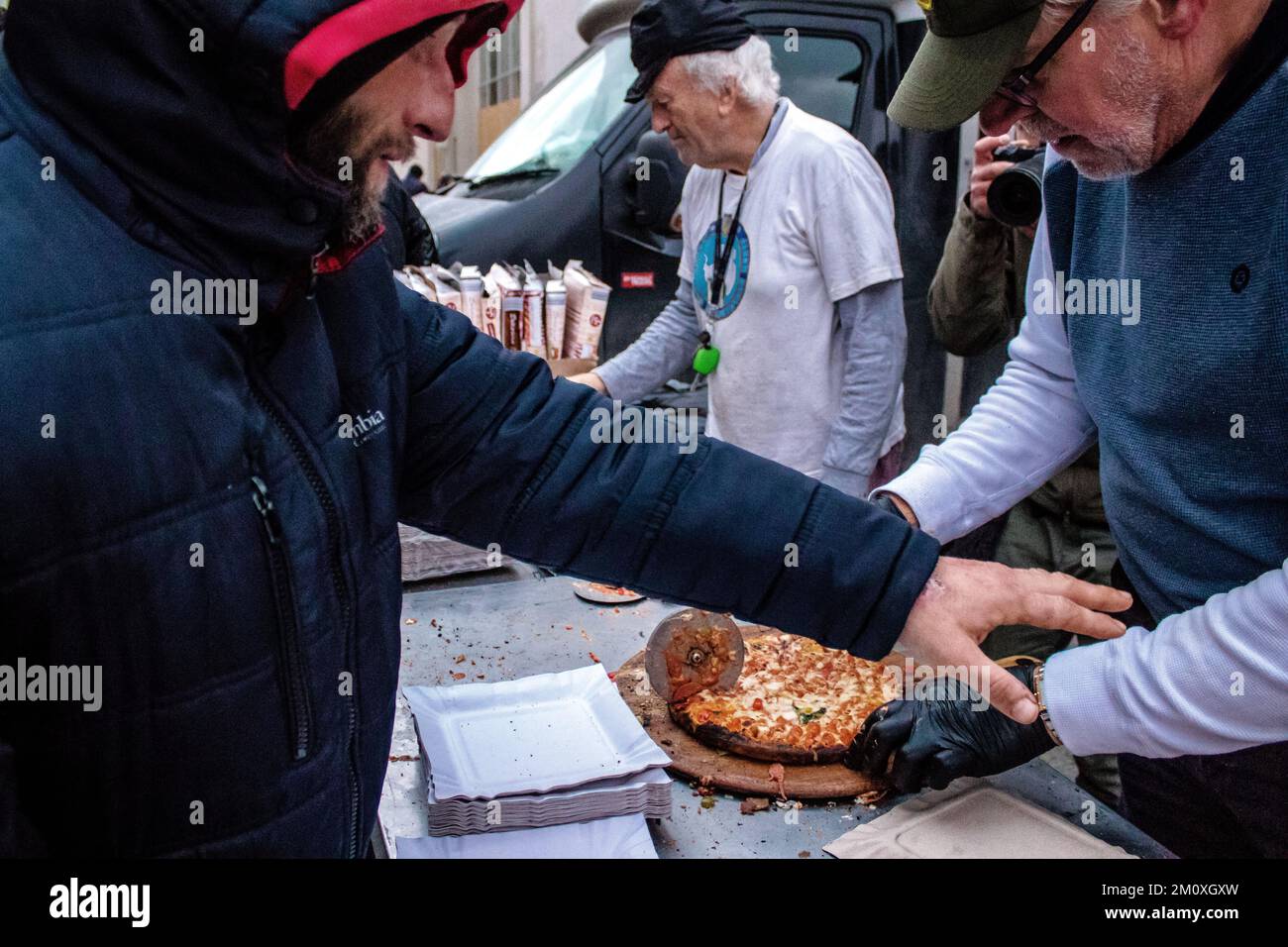 An international volunteer organization cooks and delivers pizza to the ...