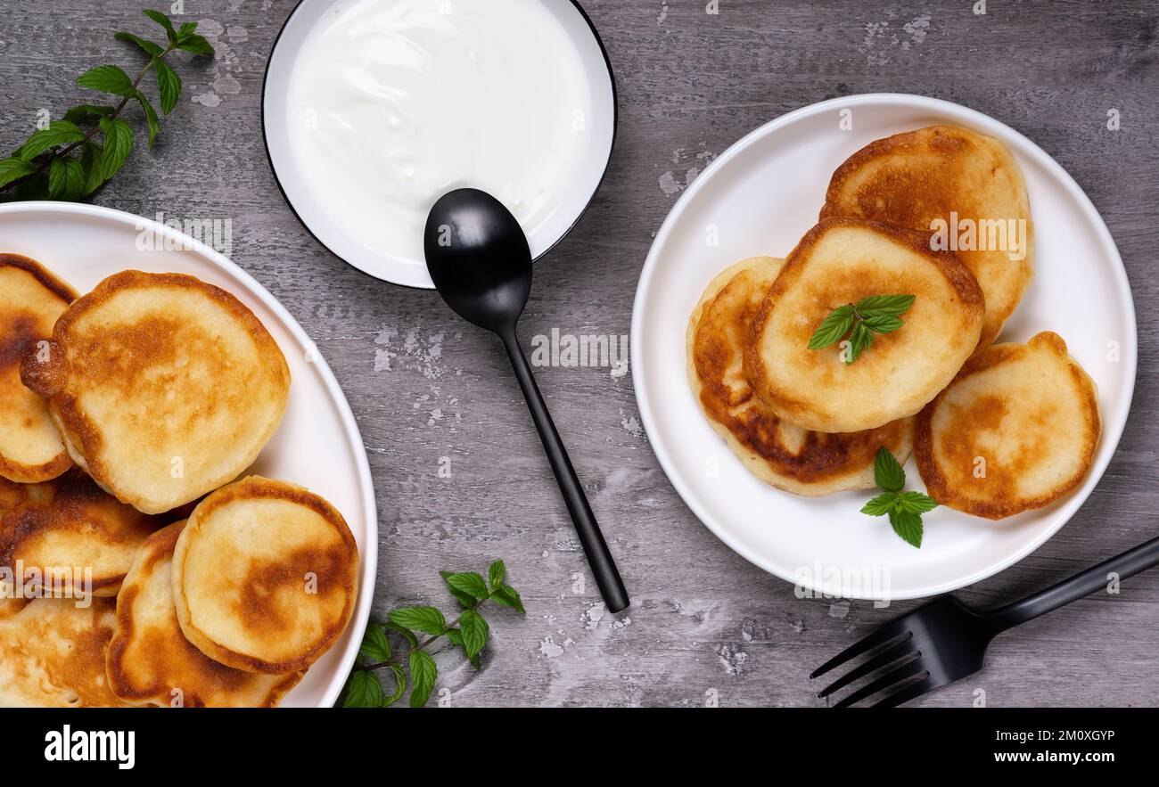 Pancakes with sour cream on a gray wooden table Stock Photo - Alamy