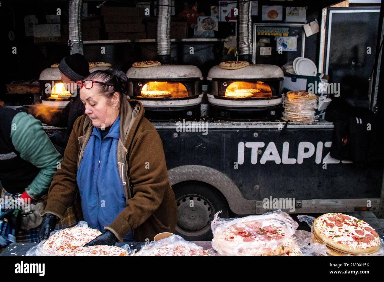 An international volunteer organization cooks and delivers pizza to the ...