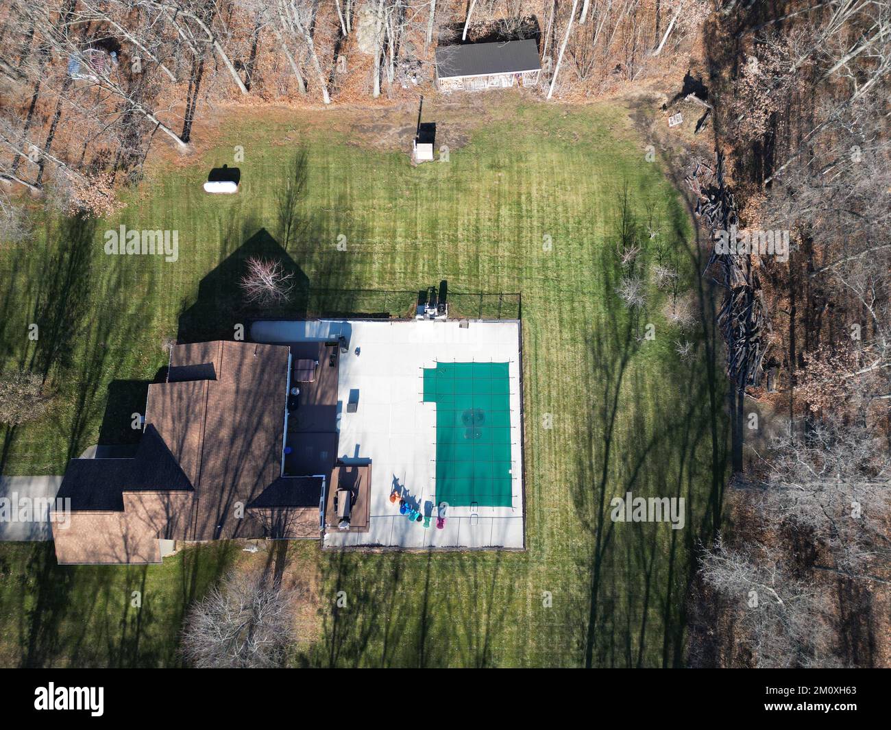 Drone view of a house with a pool and lush lawn in late fall Stock ...