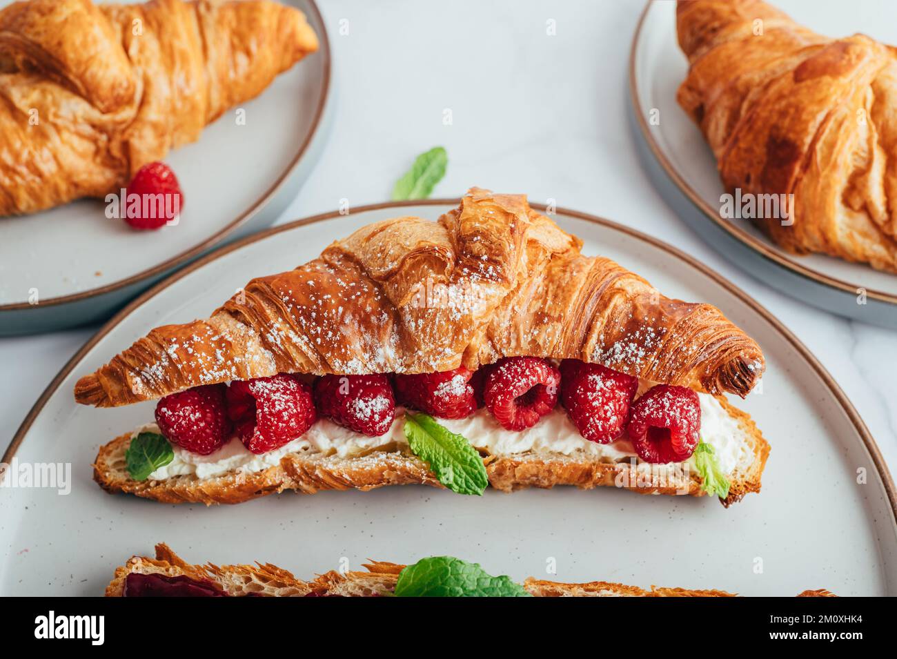 Croissant with fresh raspberries Stock Photo - Alamy