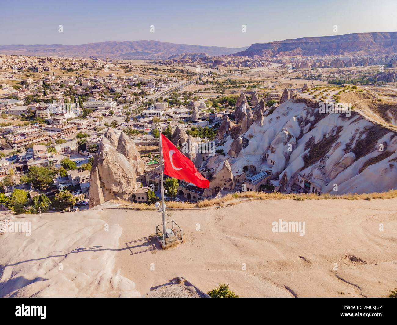 Turkish flag on the hill with typical tuff rock formations of the ...