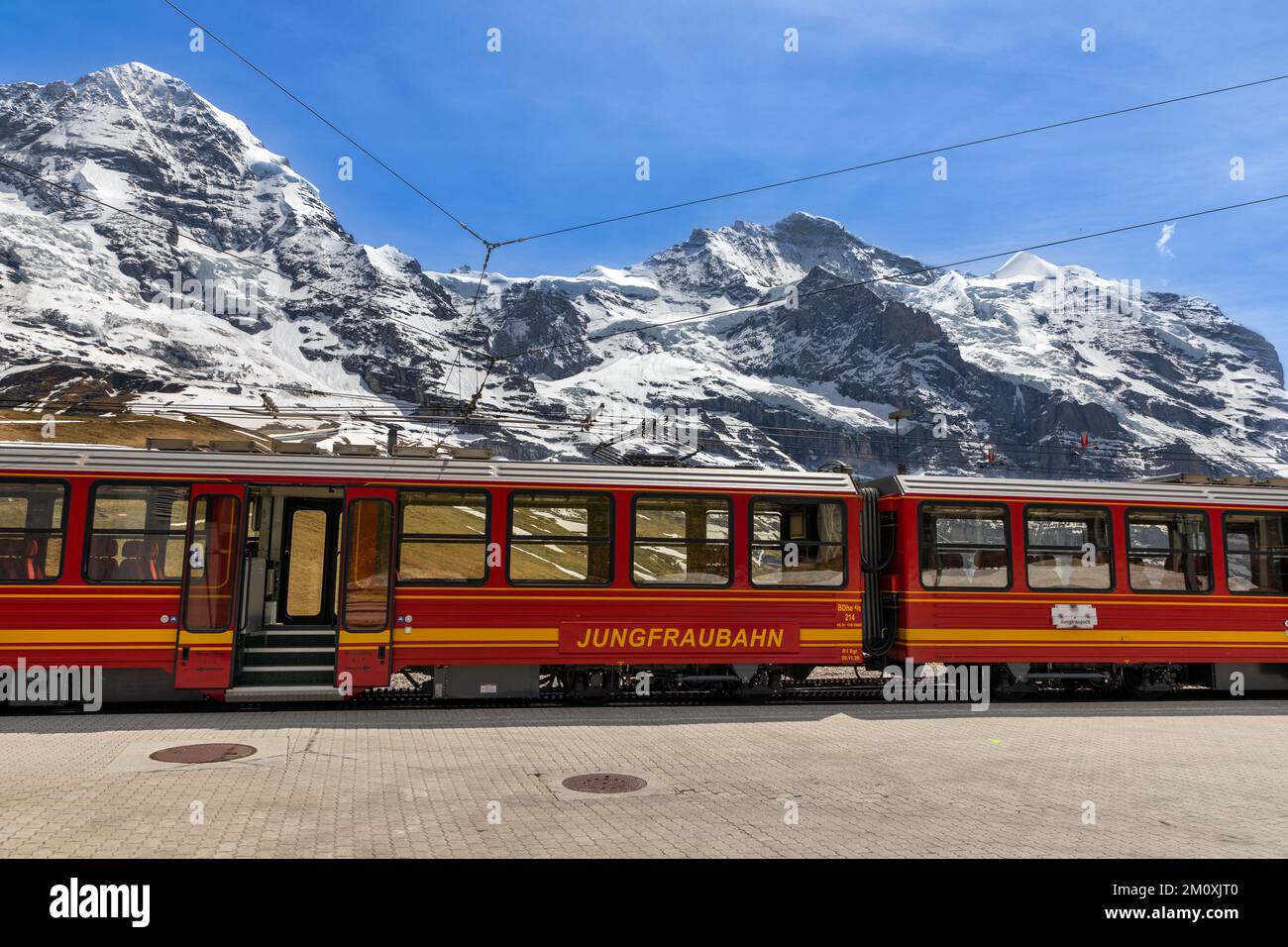 Two carriages of the Jungfraubahn train with the Monch and Jungfrau ...