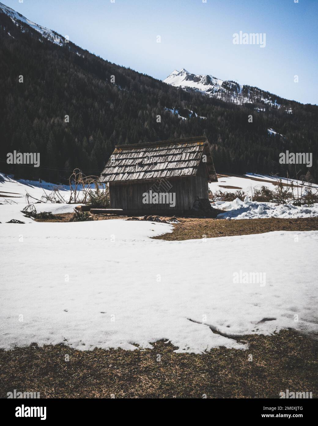 A small wooden hut in snowy valley between the Alps in Austria Stock ...