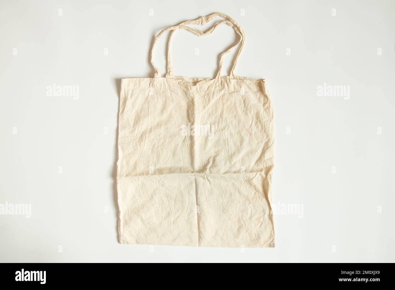 A fabric beige bag lies on a white background, a grocery bag Stock ...