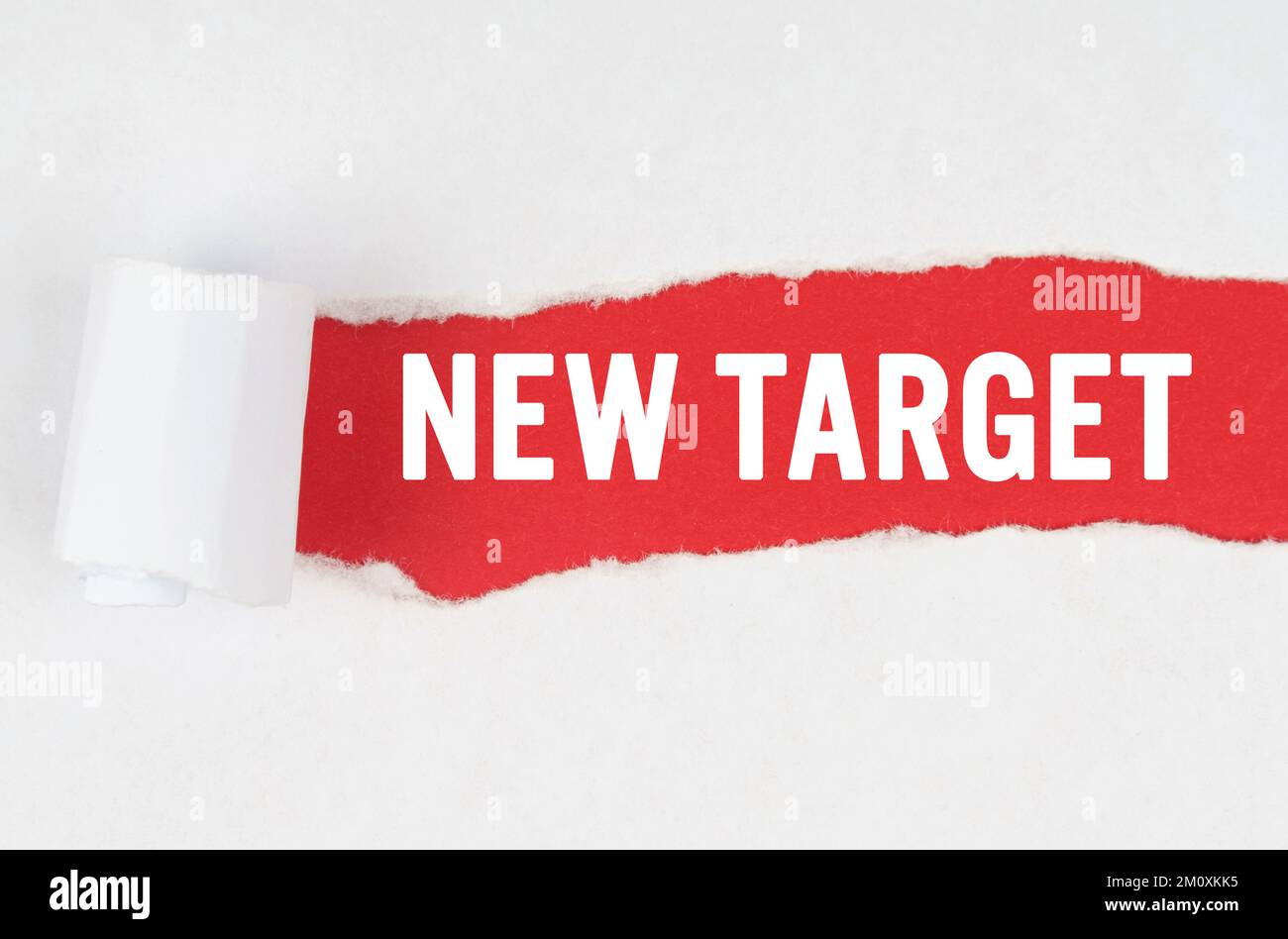 Business and finance. Behind torn white paper on a red background, the ...