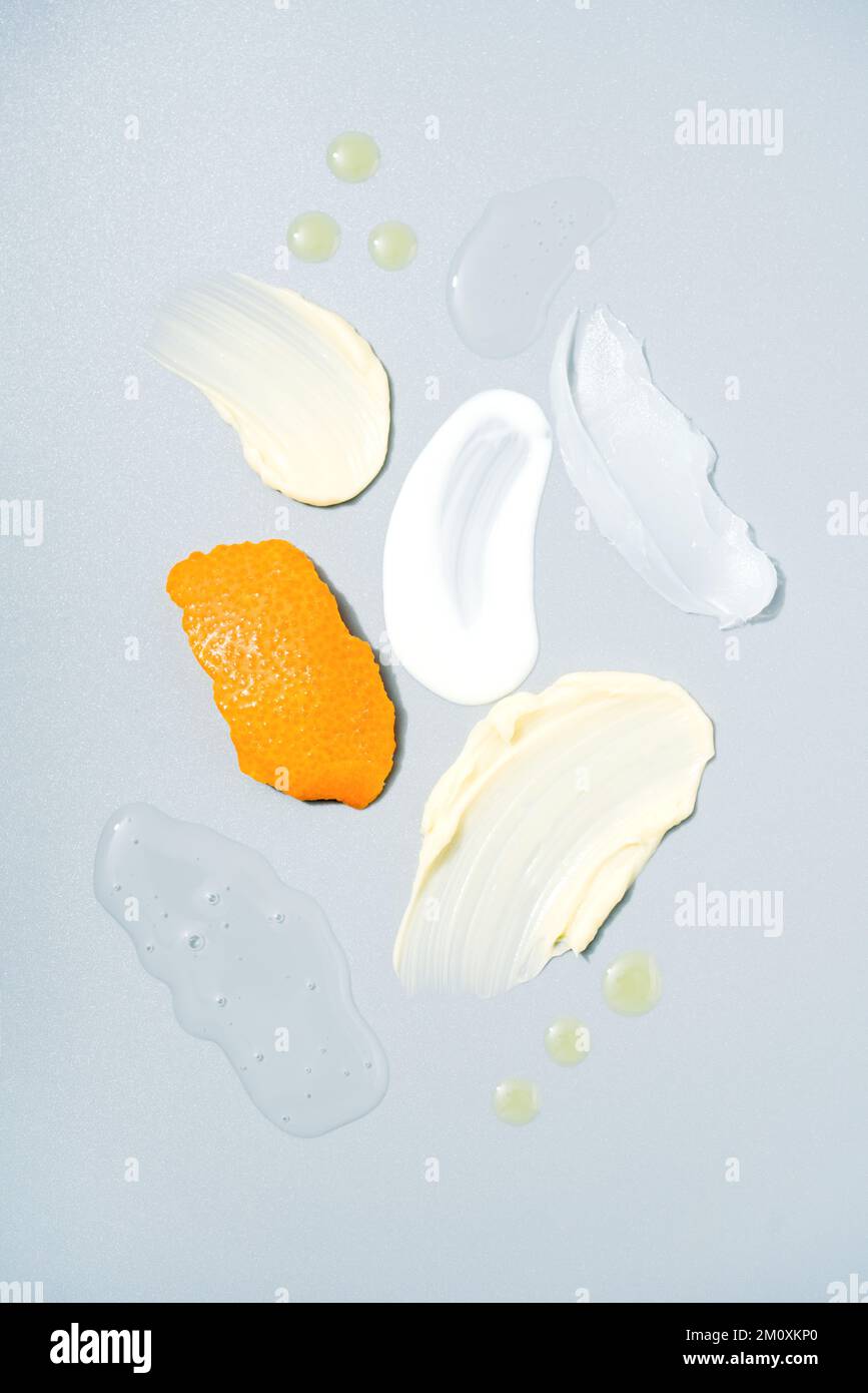 Many cosmetic products samples with vitamin C - cream and gel smears ...