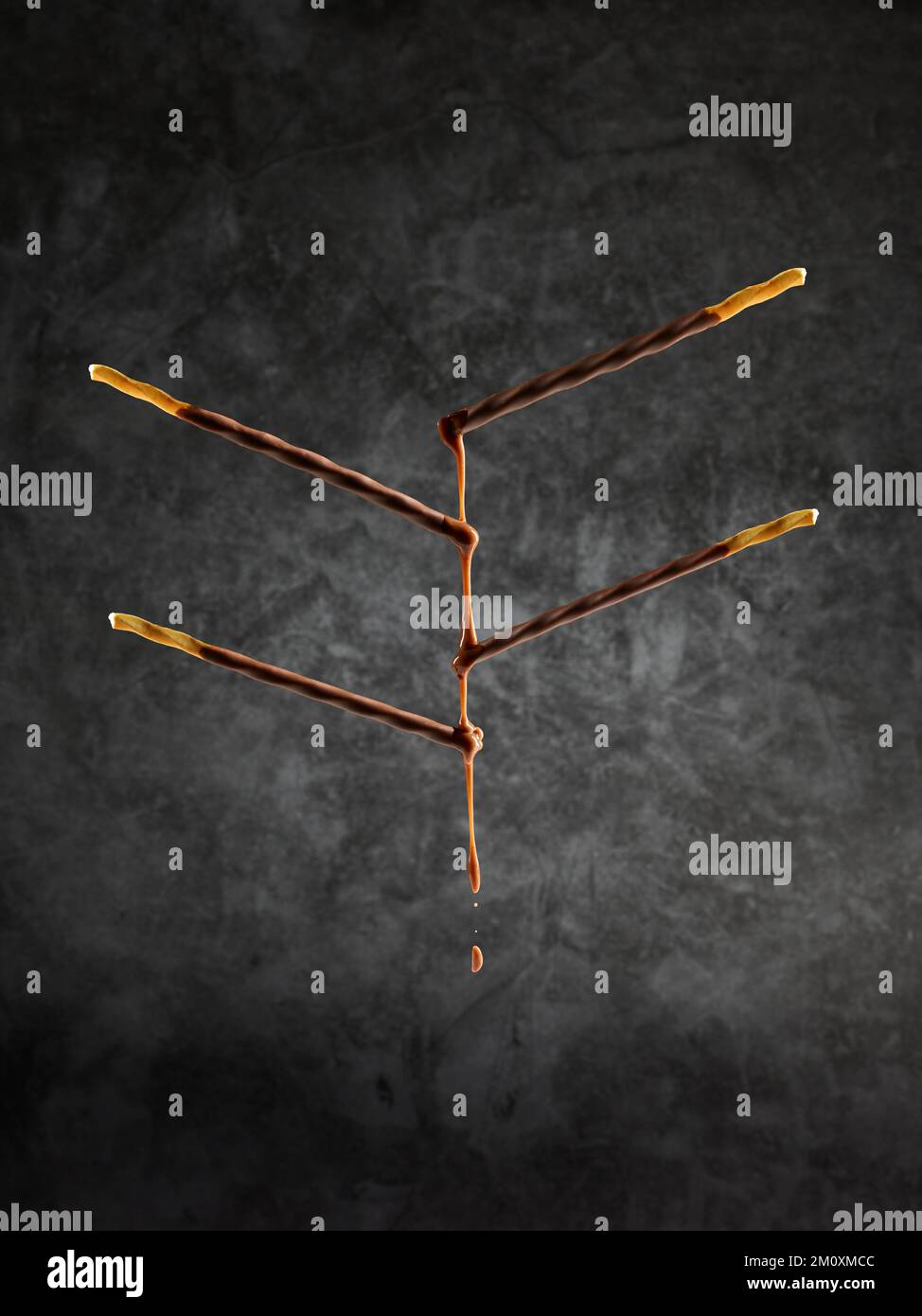 Liquid chocolate falling on chocolate sticks Stock Photo - Alamy