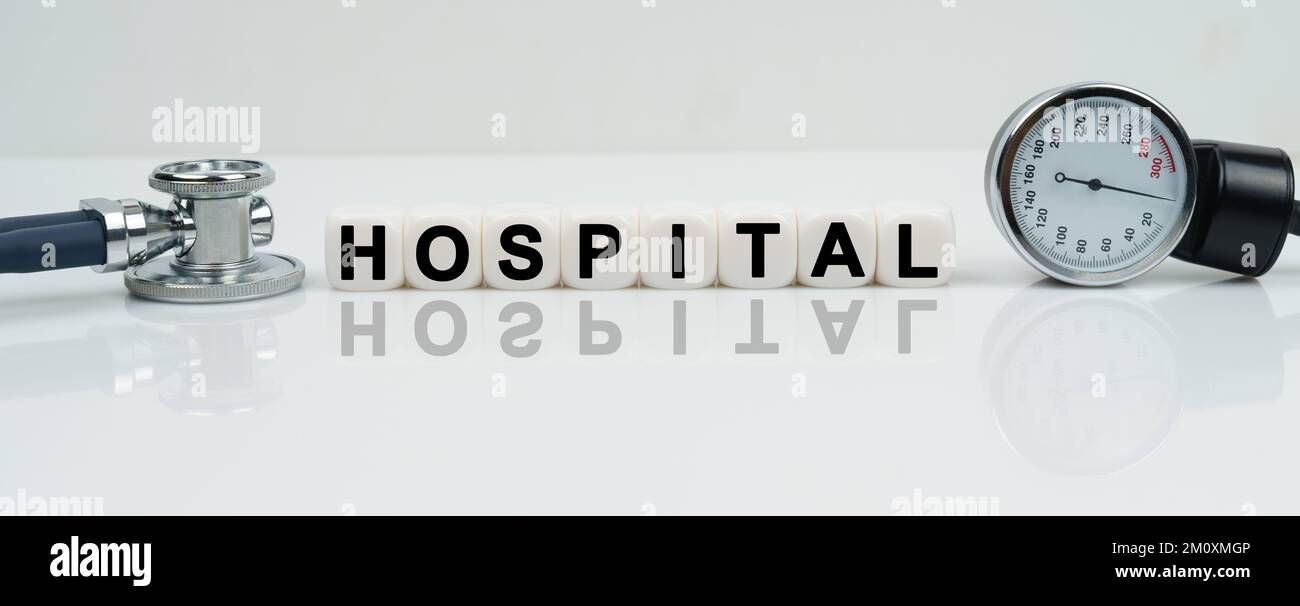 Medicine concept. On a reflective white surface lies a stethoscope and ...