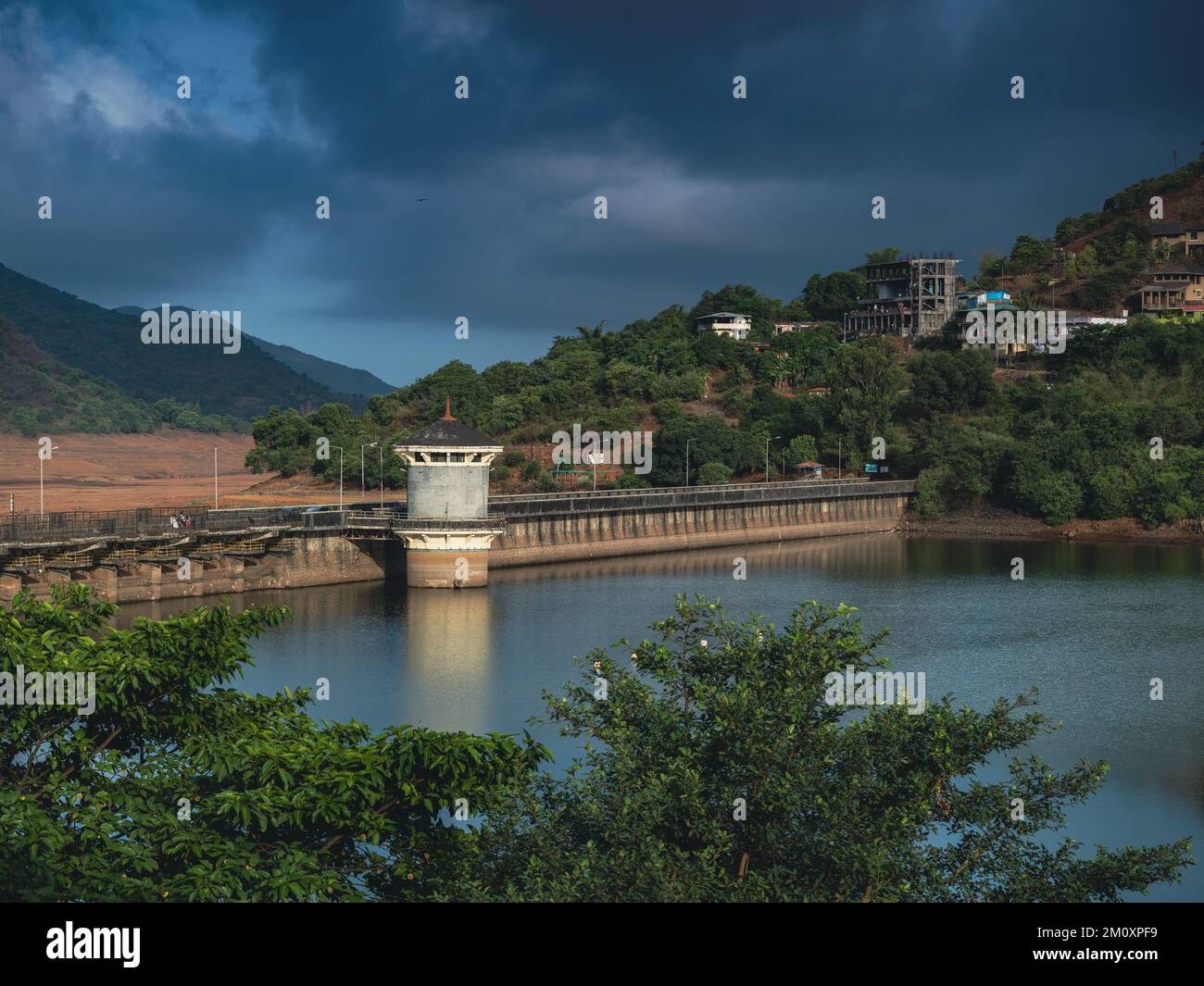 A scenic view of Lavasa city reservoir under the cloudy sky Stock Photo ...