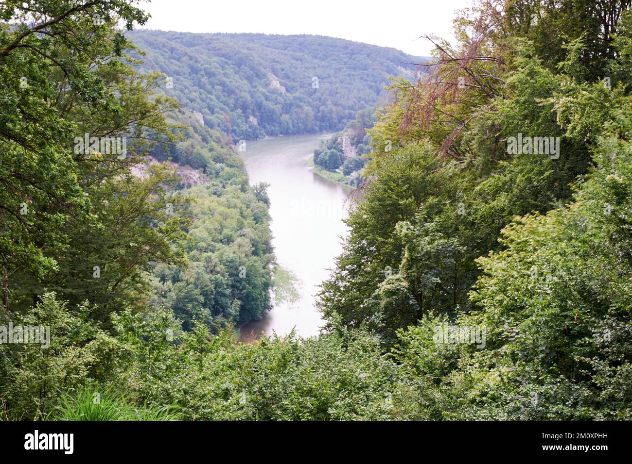A beautiful natural view of the river in the middle of hills covered by ...