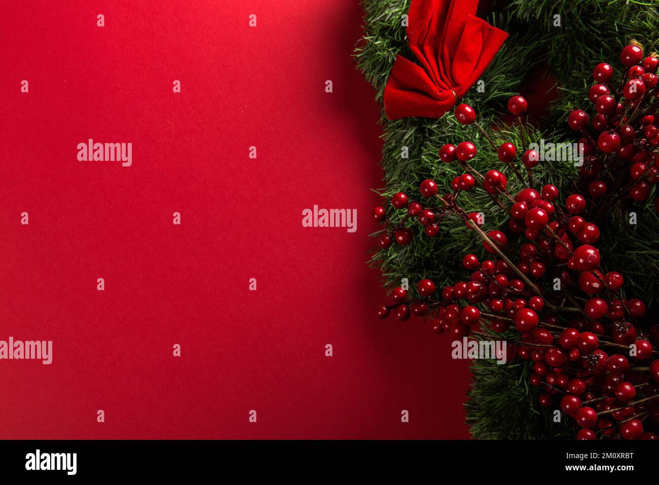 A Christmas red background decorated with garland Stock Photo - Alamy