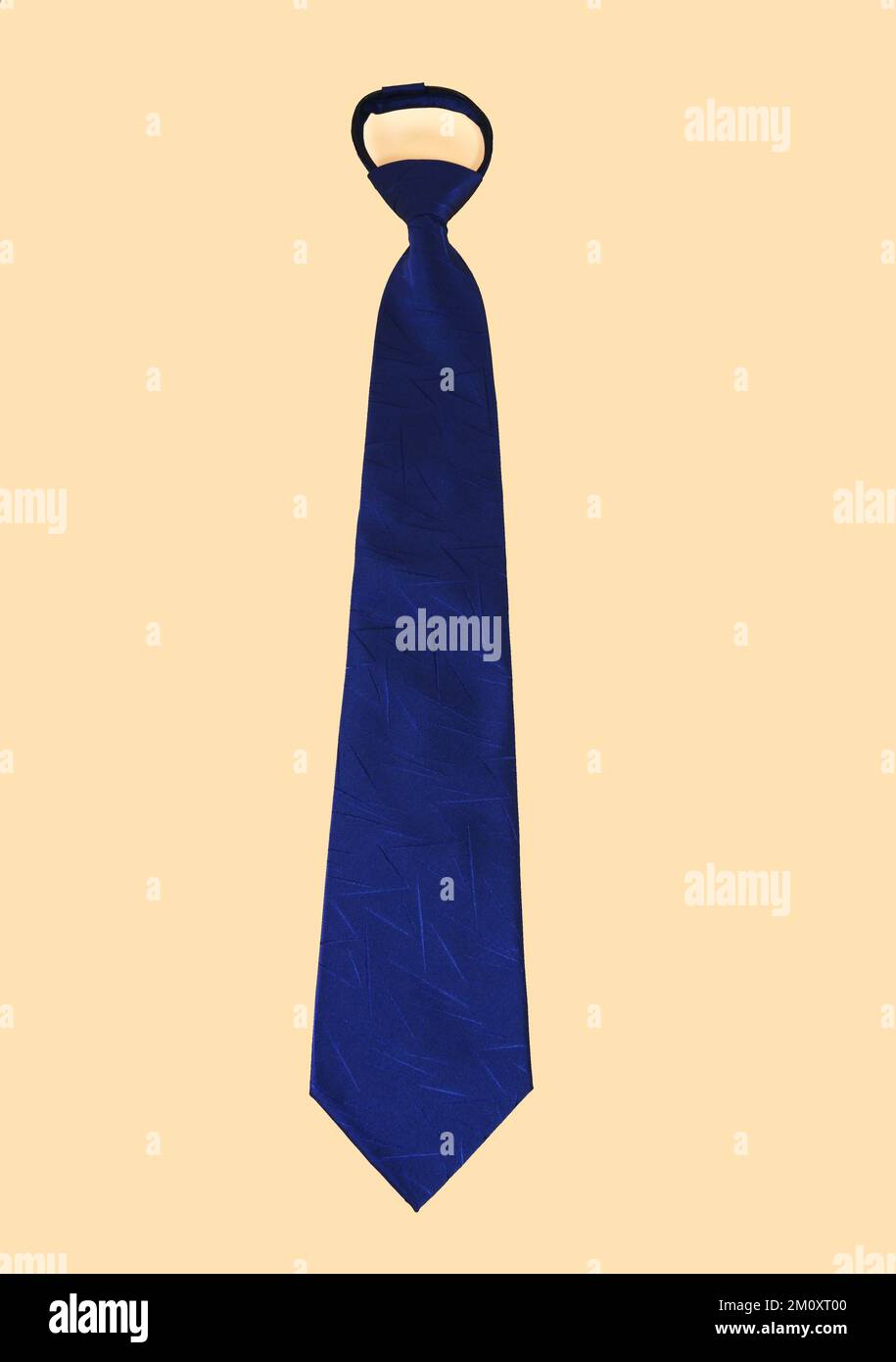 A vertical shot of a blue polyester necktie isolated on a yellow ...