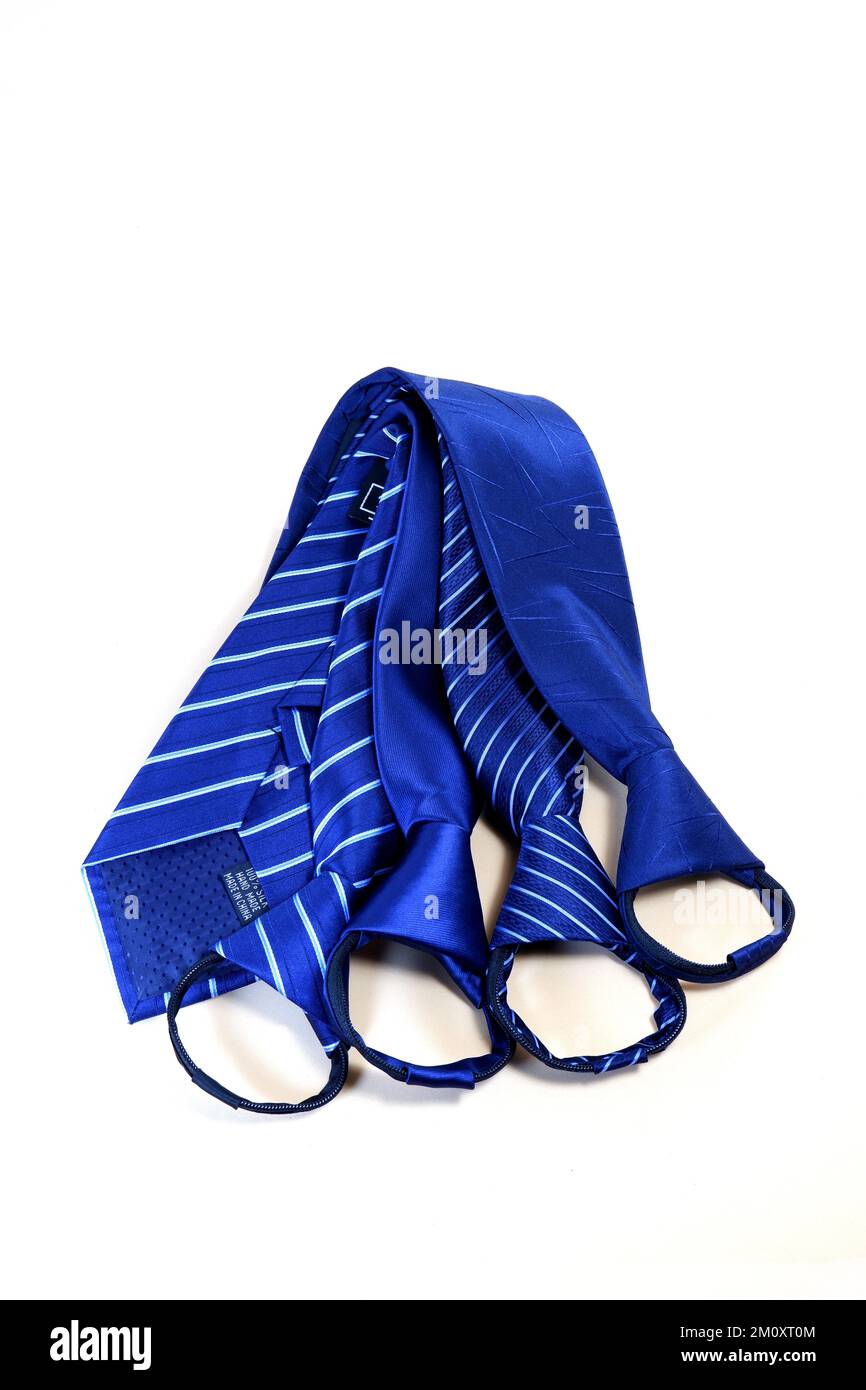 A vertical shot of a group of blue polyester neckties isolated on a ...