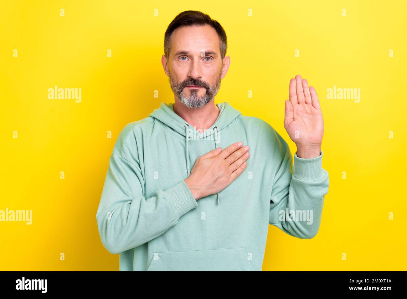 Photo of serious confident man showing hand palm make oath promise be ...