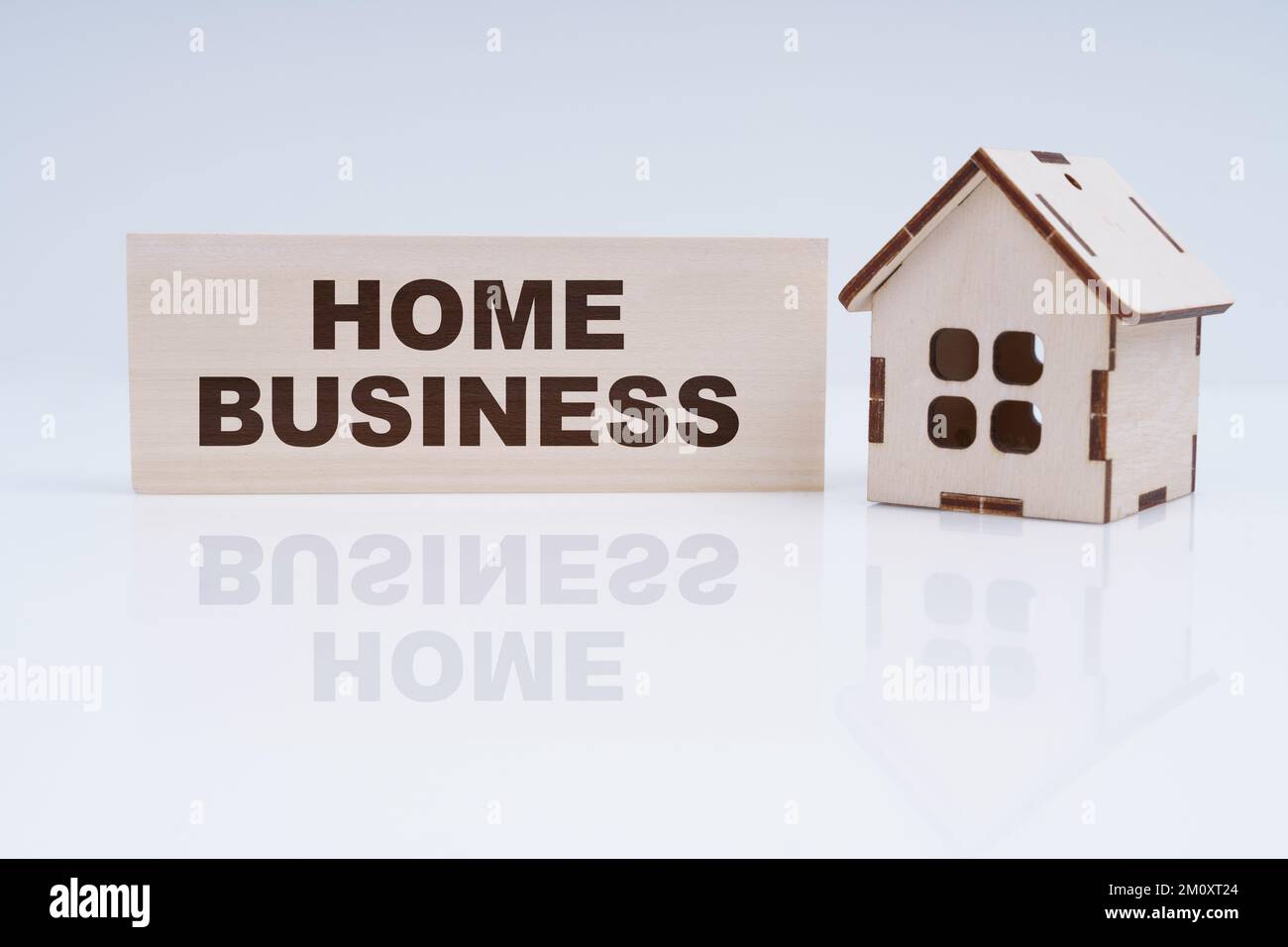 Economy and business concept. There is a wooden house and a sign on the ...