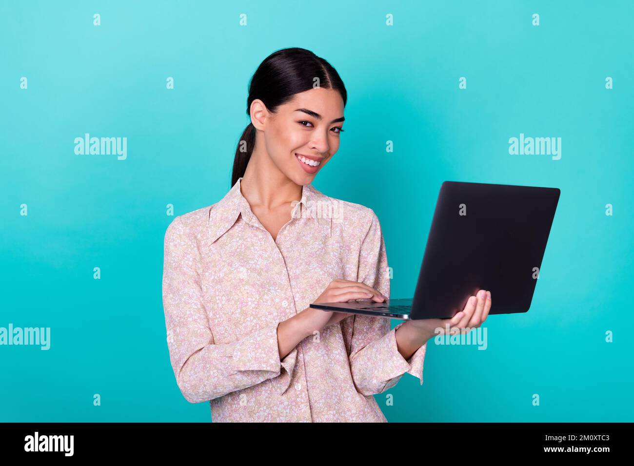 Photo of cheerful nice thai girl toothy smile hold wireless netbook ...