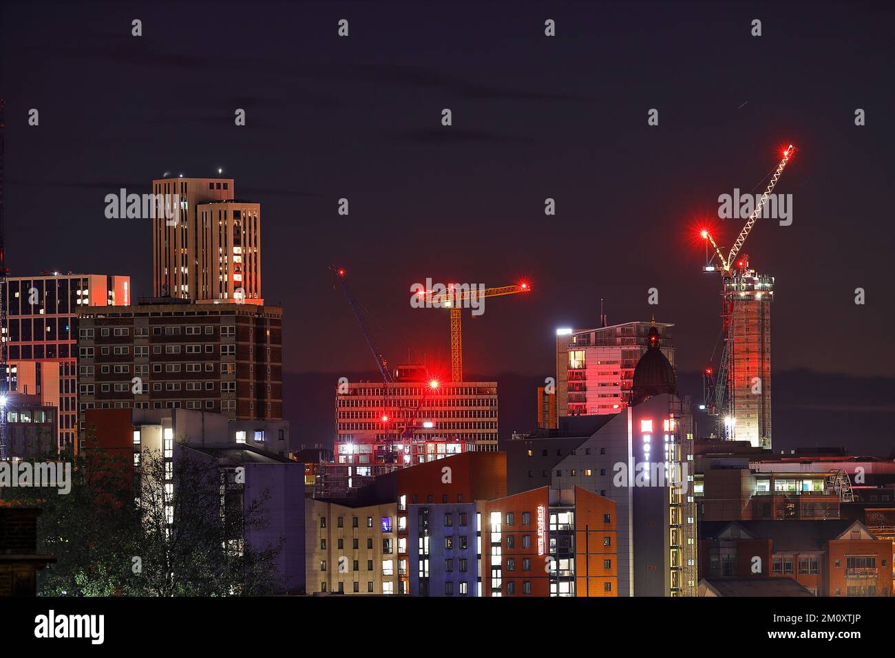 Leeds City at night with various tower cranes on construction projects ...