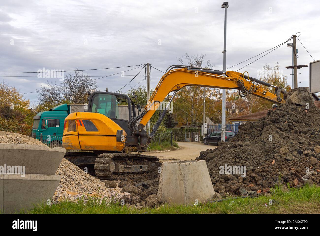Excavator Digging Dirt for Utility Sewer Pipes Construction Work Stock ...